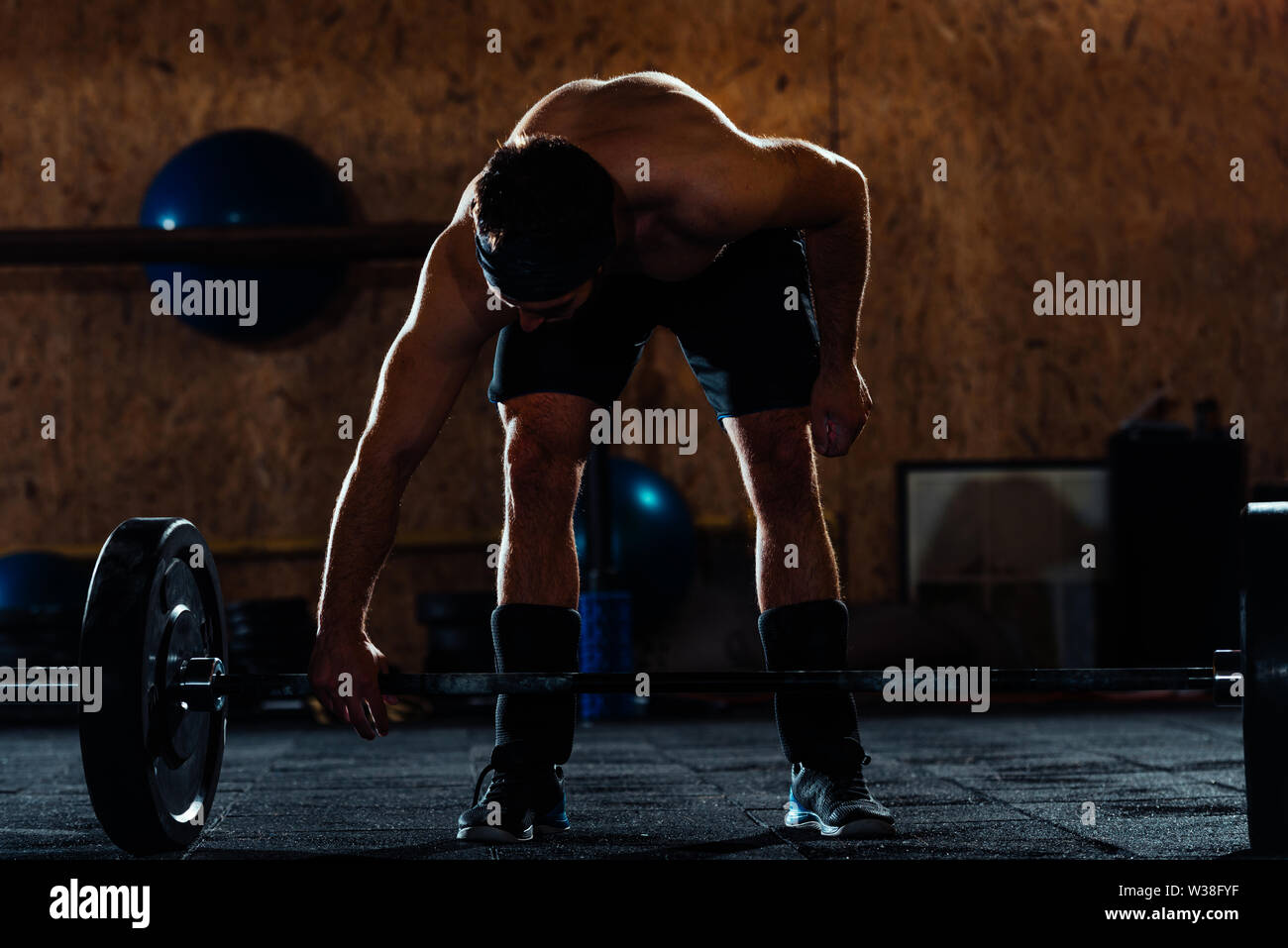 Fitness man is raising barbell in the gym Stock Photo - Alamy