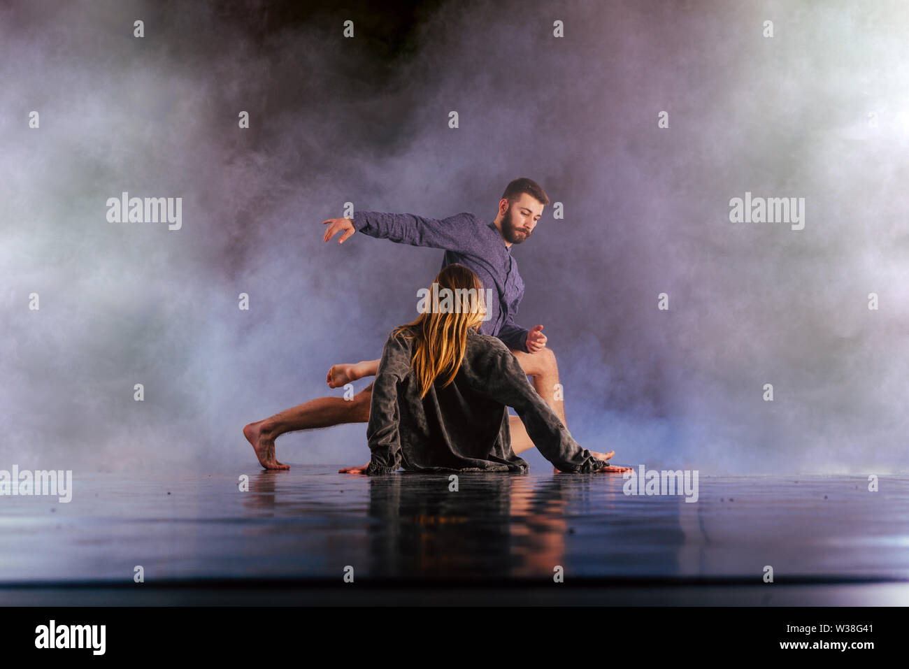 Shoeless dance couple performing multiple unique dance moves in front ...