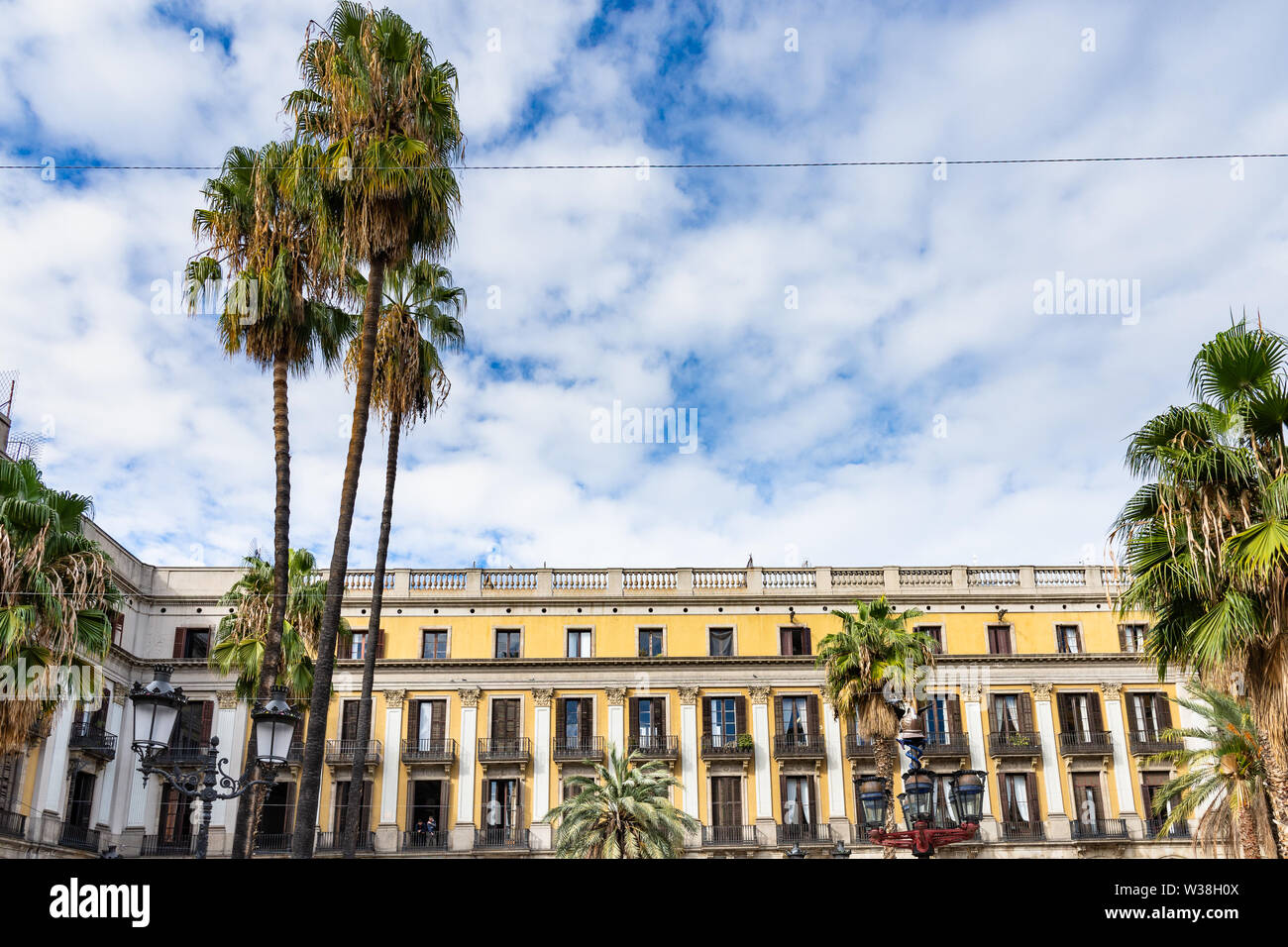 Placa Reial, shaded by palms and decorated by Gaudi street lights ...
