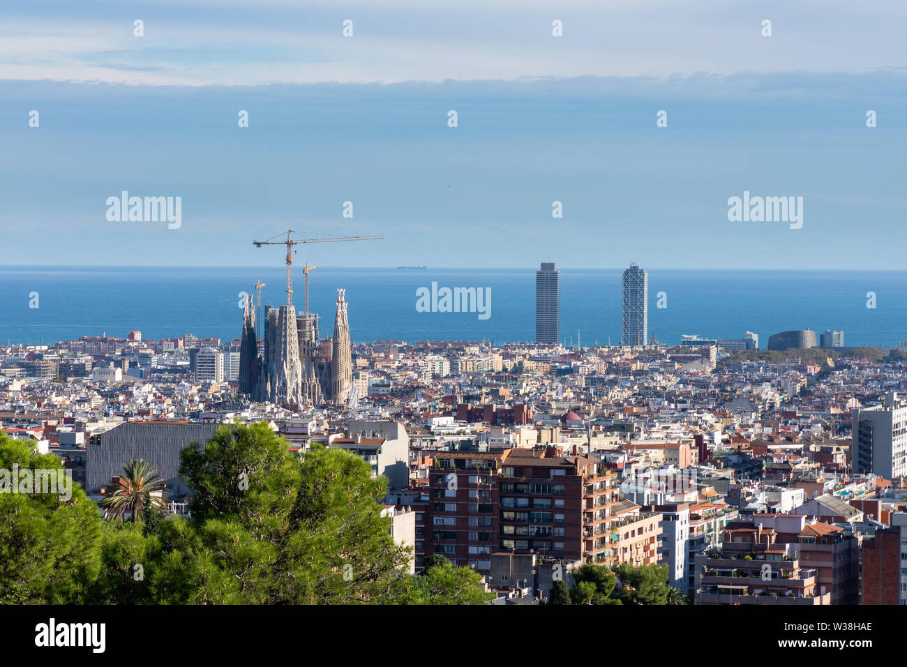 View of the roofs of Barcelona from Parc Guell terrace. La Sagrada ...