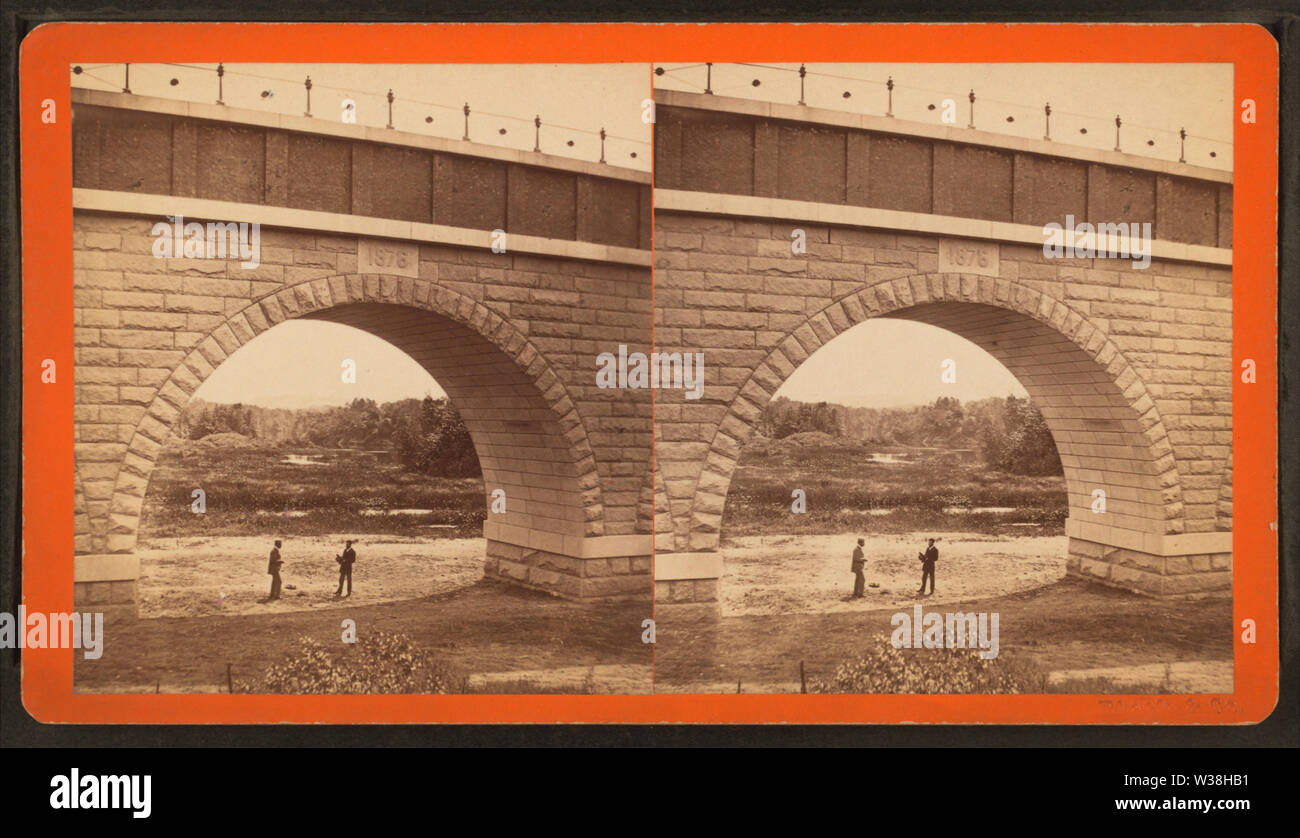 View of two people standing under completed arch, from Robert N Dennis ...