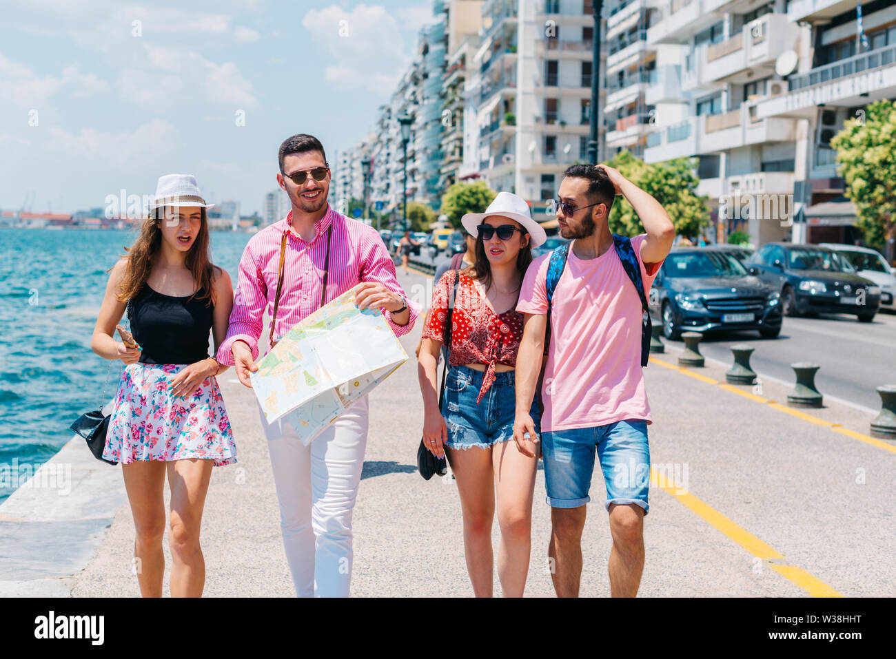 Tourists looking at a map and planning the places they are supposed to ...