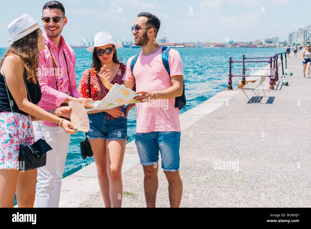 Tourists looking at a map and planning the places they are supposed to ...