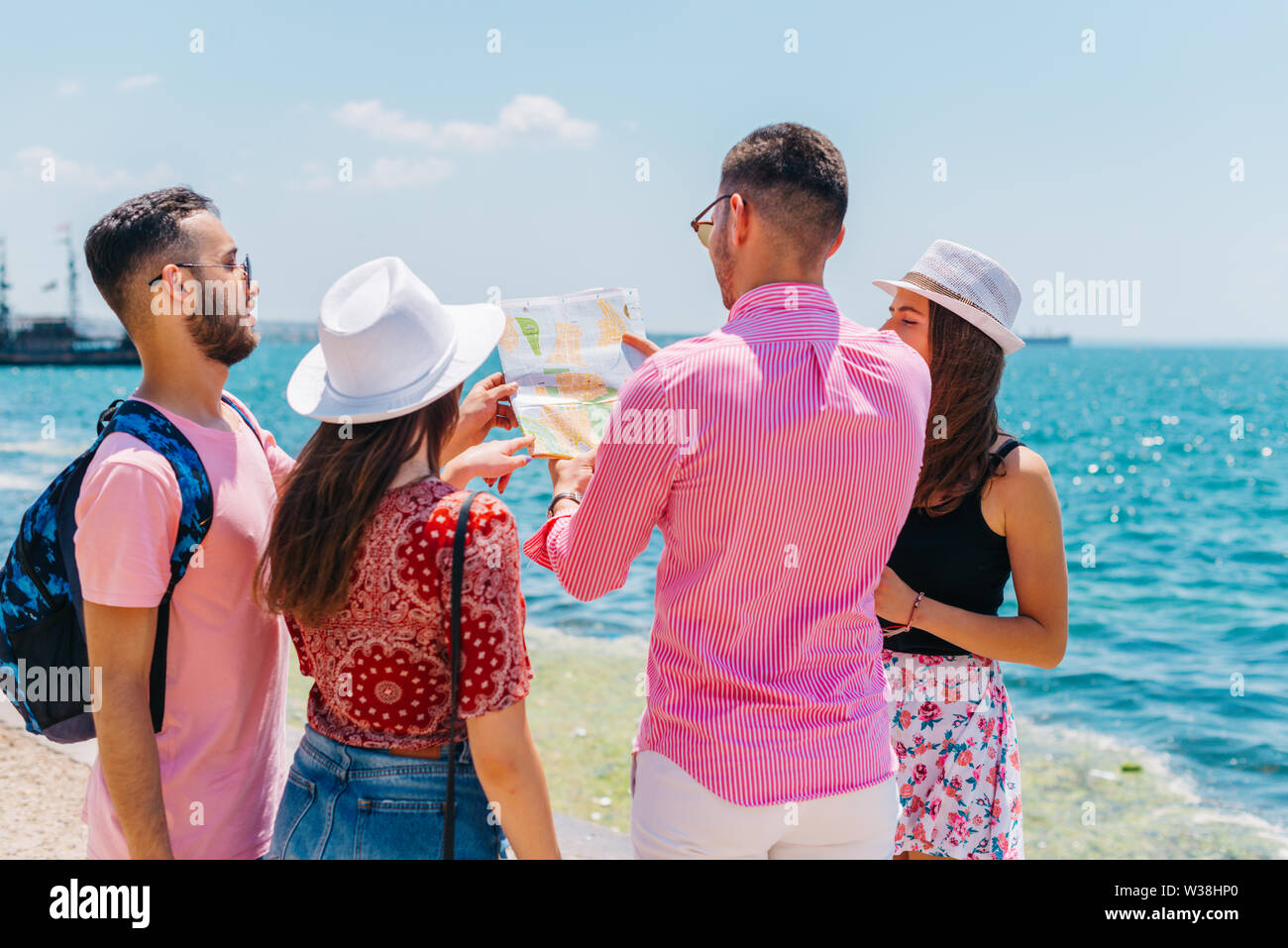 Tourists looking at a map and planning the places they are supposed to ...