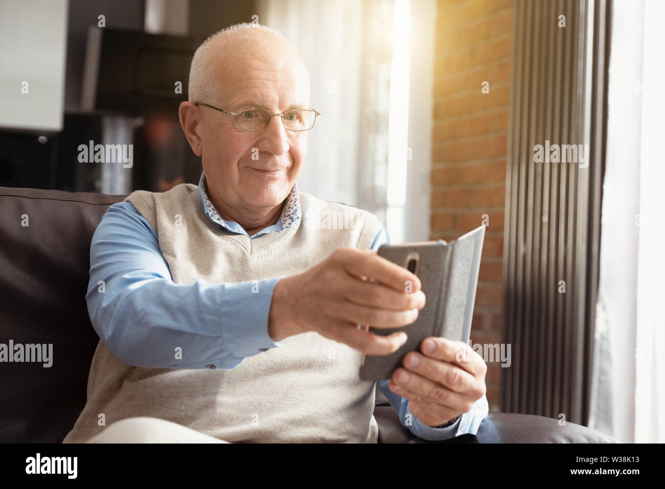 Happy older man using phone hi-res stock photography and images - Alamy