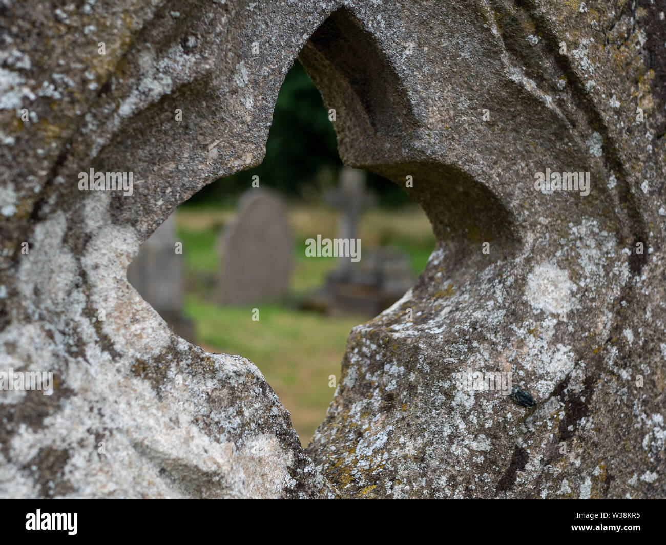 Looking through the cross shaped hole of a grave stone in Histon Road ...