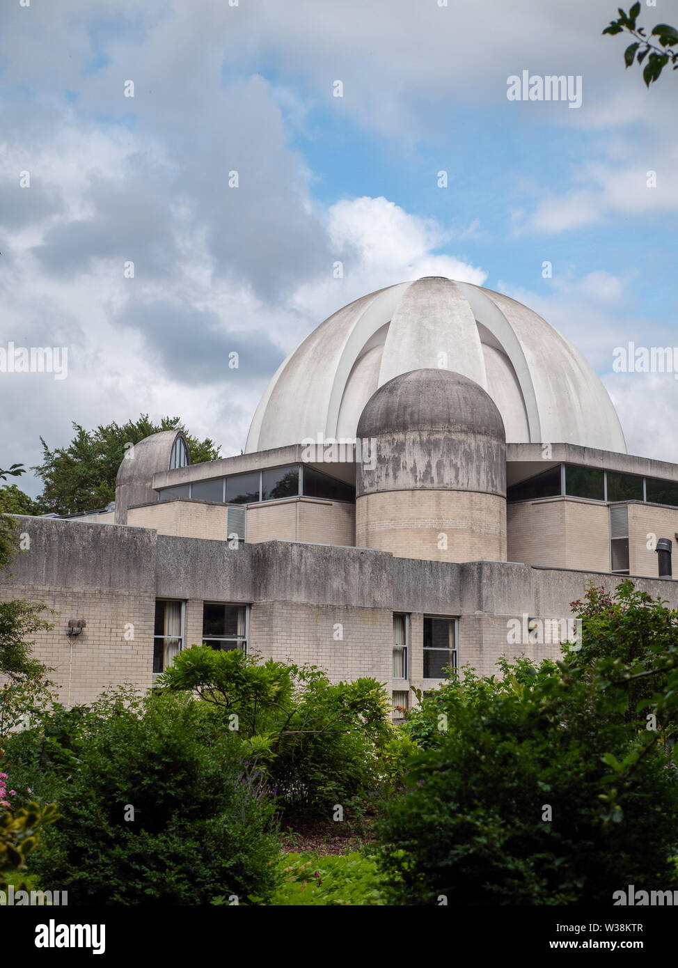 The dome of Murray Edwards College against a cloudy sky. The college ...