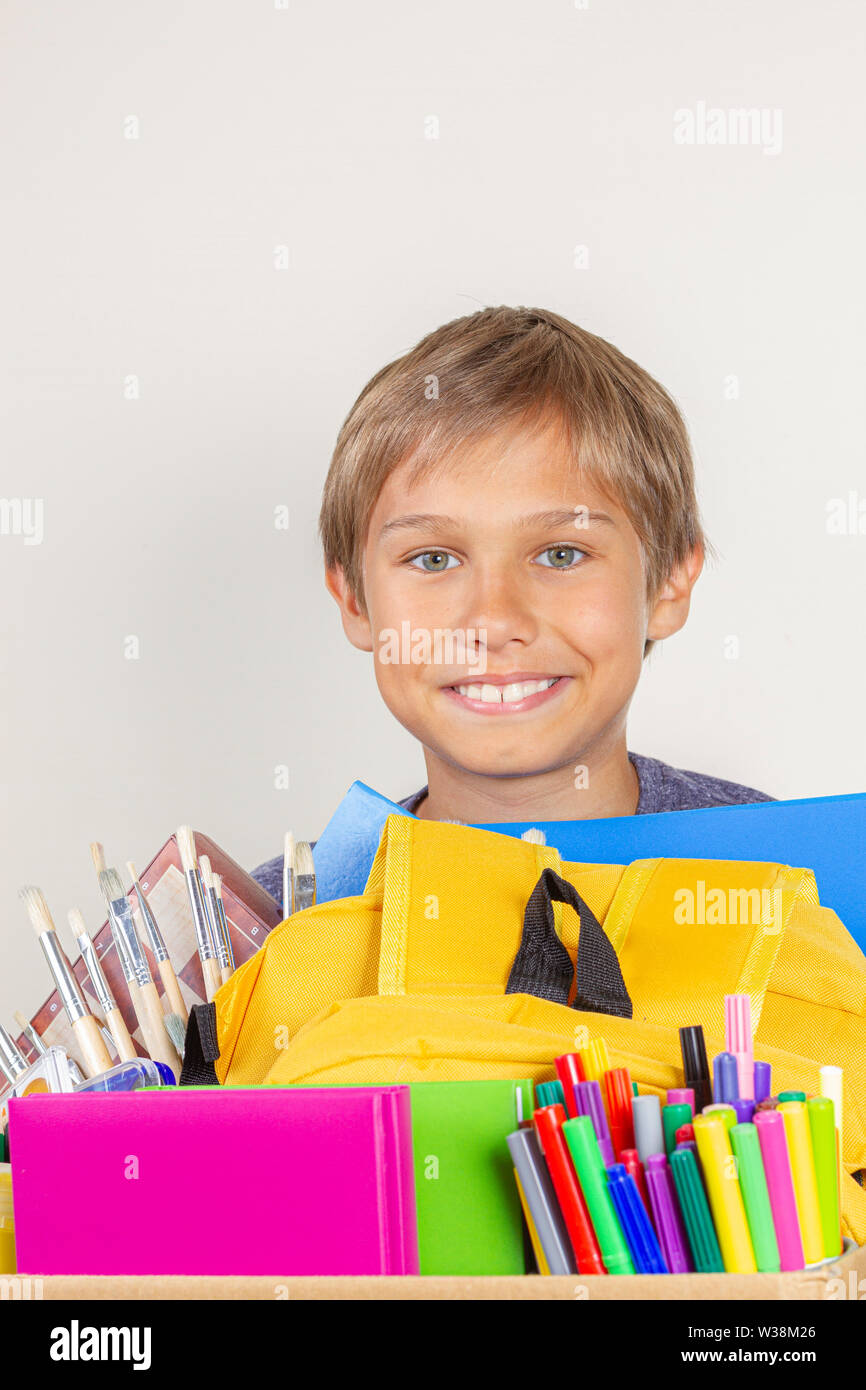 Donation concept. Kid holding donate box with books, pencils and school ...