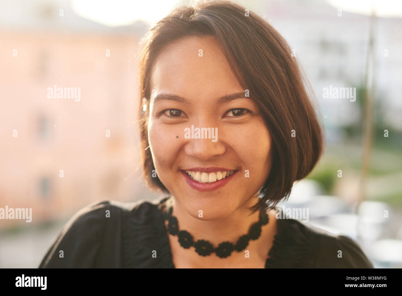 woman smiling to camera Stock Photo - Alamy
