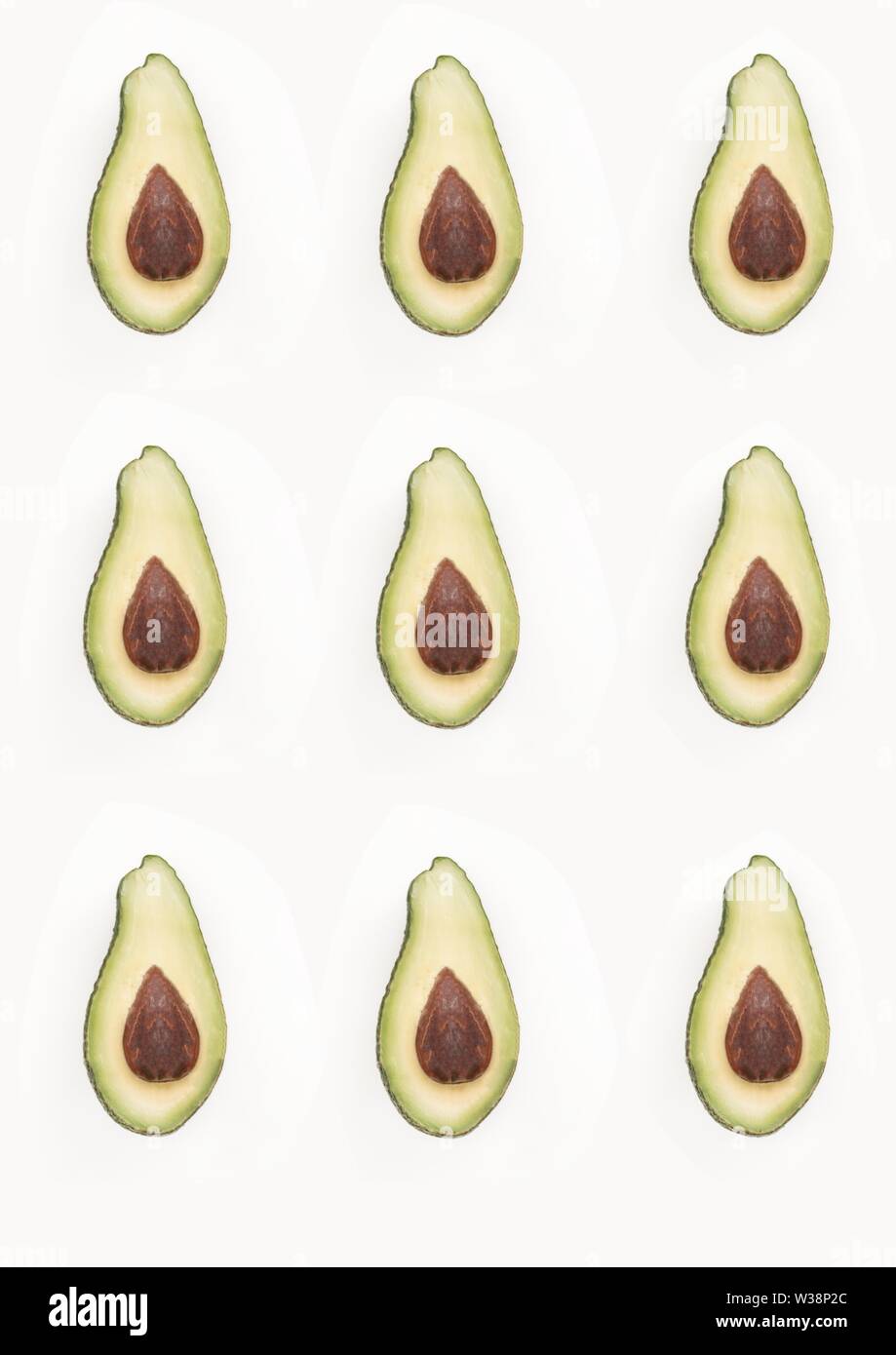 Abstract wallpaper with sliced avocados on a light background Stock ...