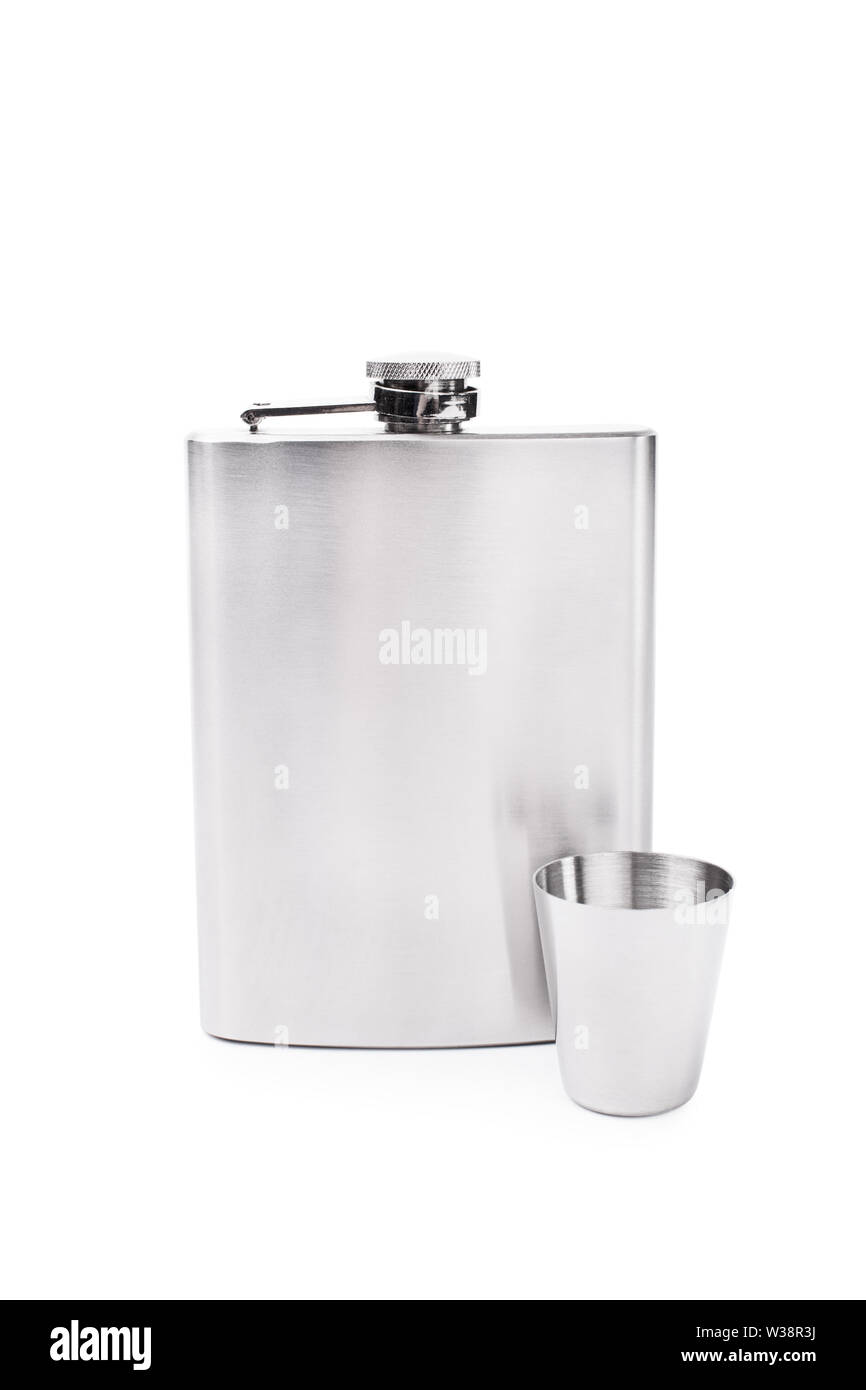 Stainless steel flask with a small metal cup, placed next to each other ...
