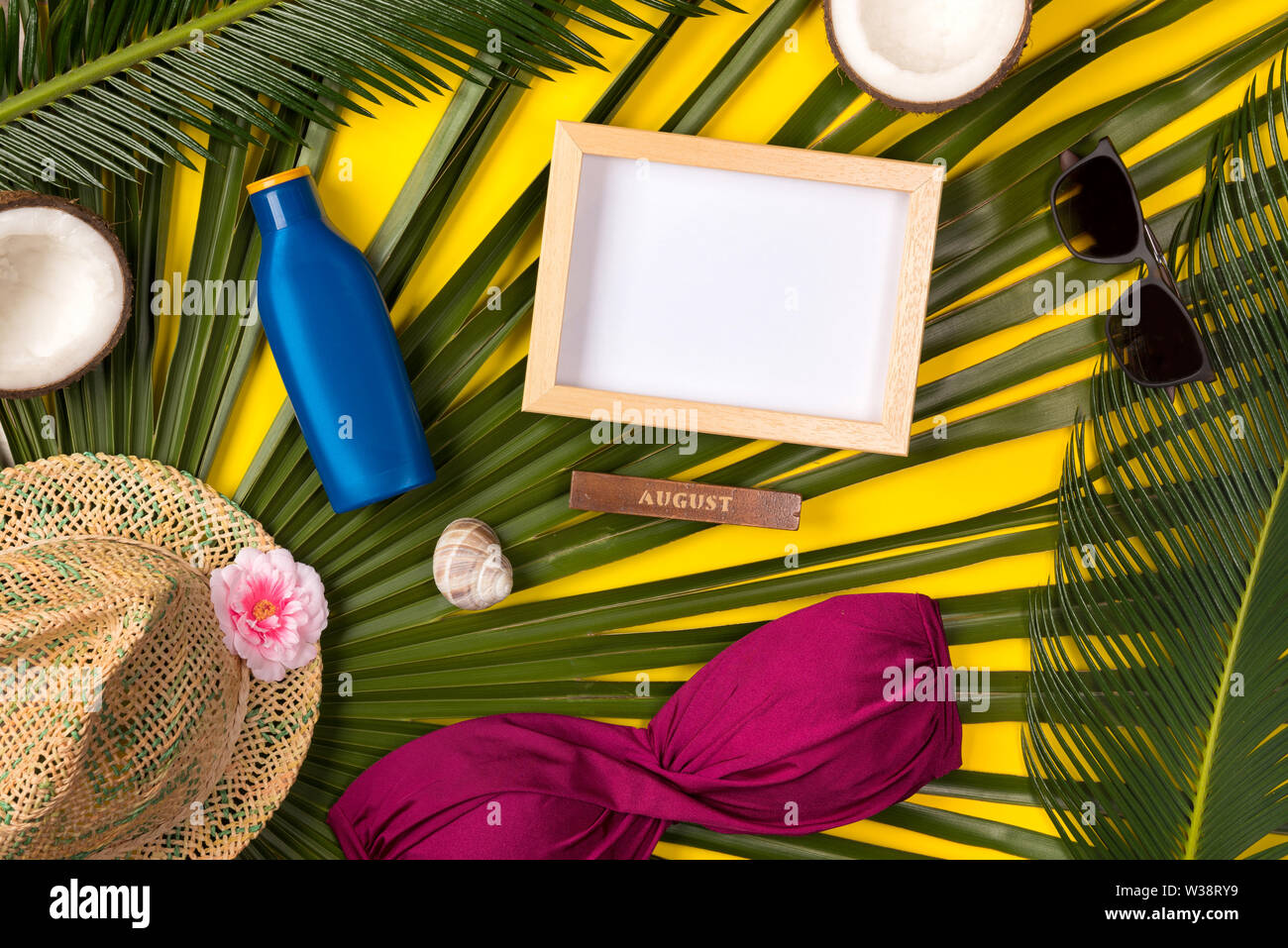 Beach theme on yellow background. Beach accessories, palm leaves, photo ...