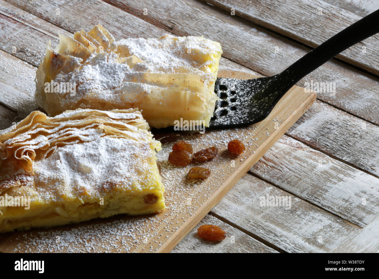 Traditional greek cuisine. Bougatsa, phyllo pastry filled with cream ...