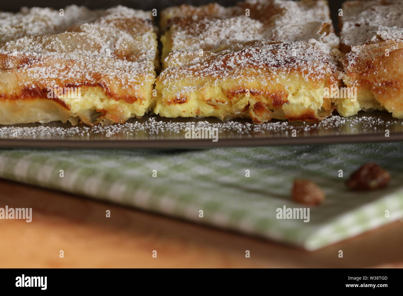 Traditional greek cuisine. Bougatsa, phyllo pastry filled with cream ...