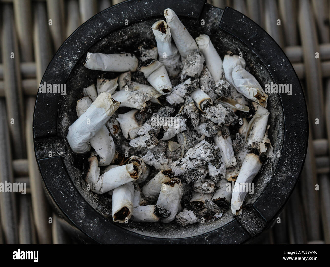close up of Filled ashtray with cigarettes and ash outside Stock Photo ...