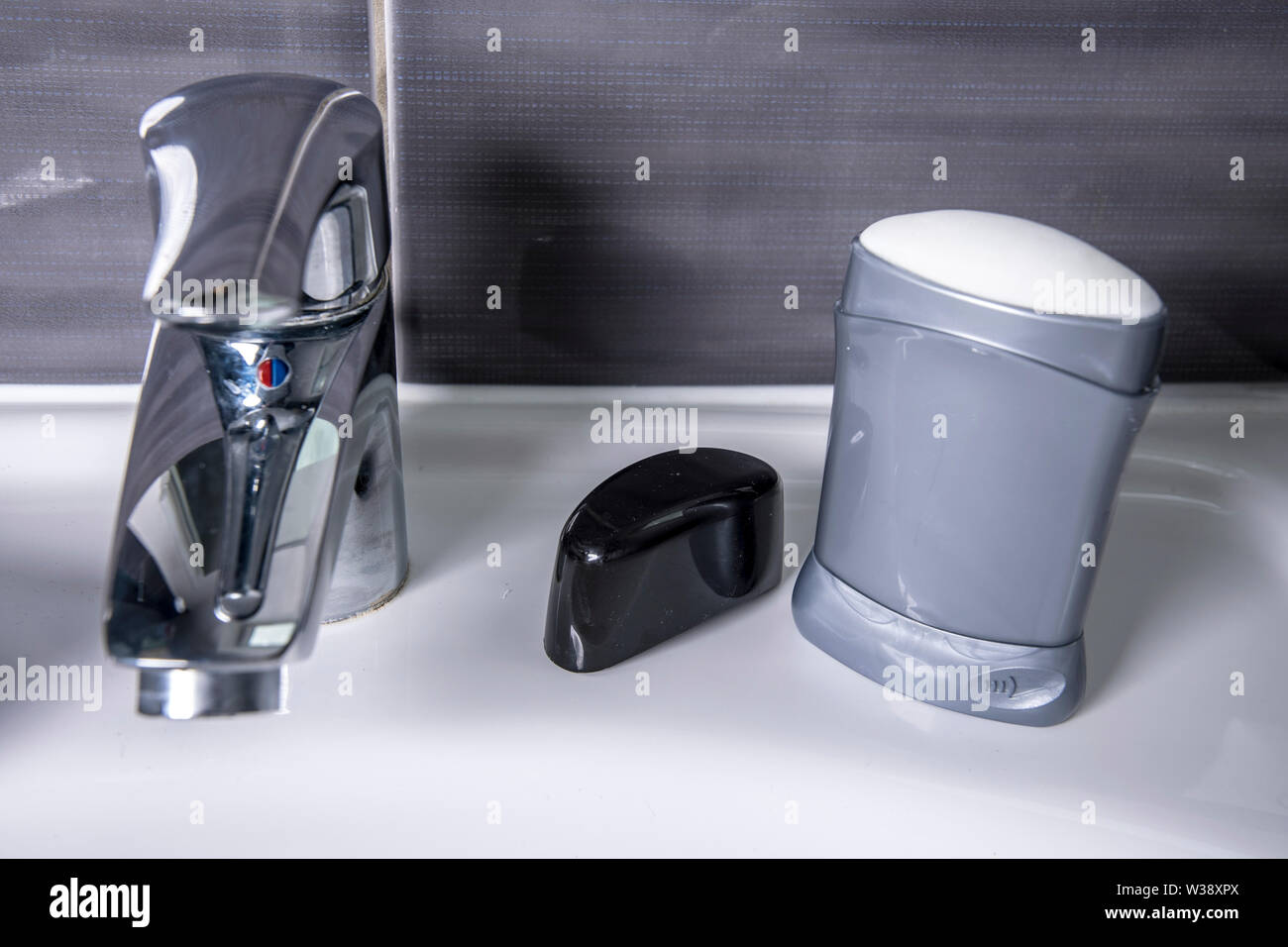 Deodorant in the bathroom with grey wall Stock Photo - Alamy