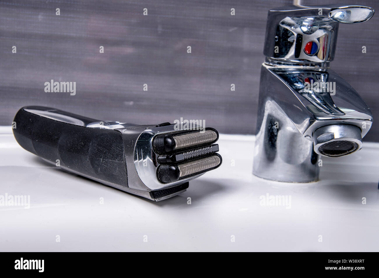 Shaver with silver tap in the bathroom Stock Photo - Alamy