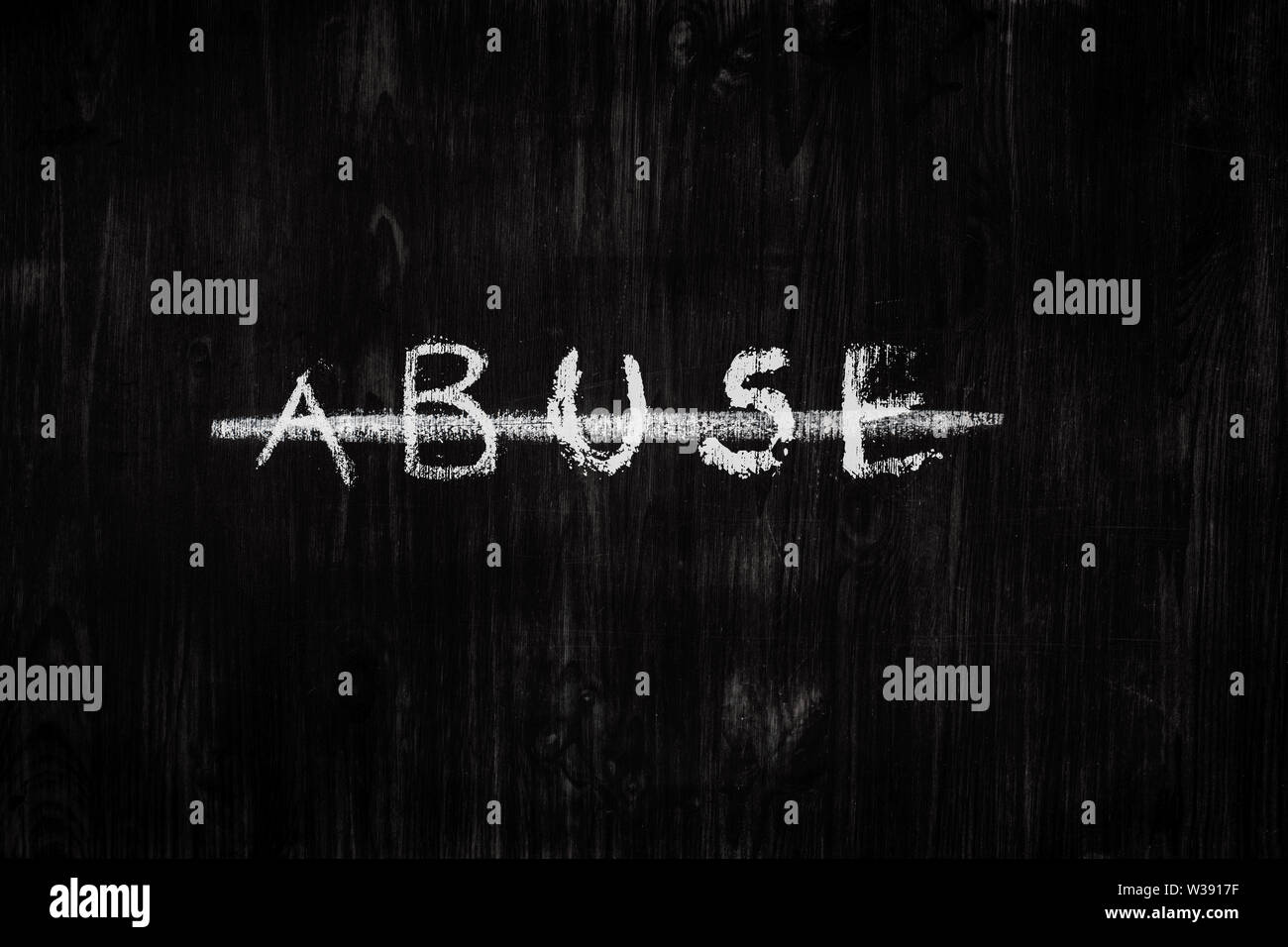 Abuse word crossed out on black wood background. Sign, concept of ...