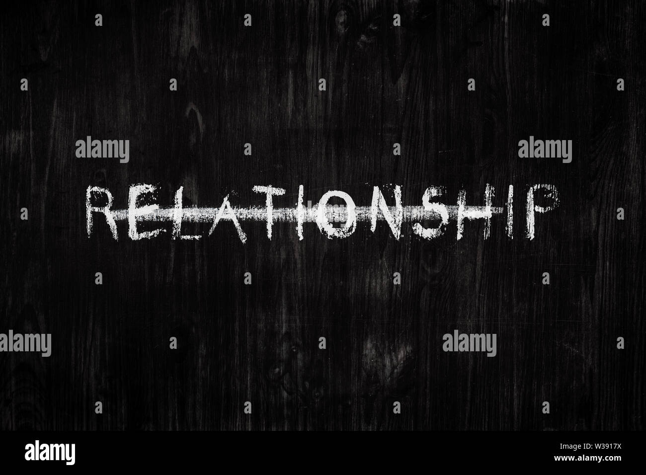 Relationship word crossed out on black wood background. Sign, concept ...