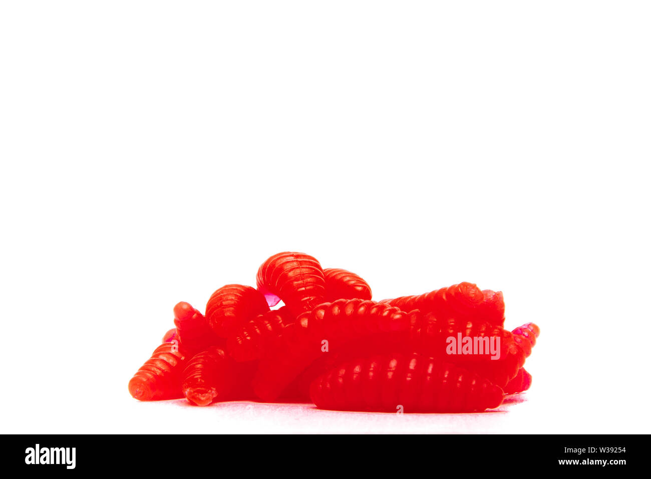 Red Artificial fishing larvae of insects on white background with soft ...