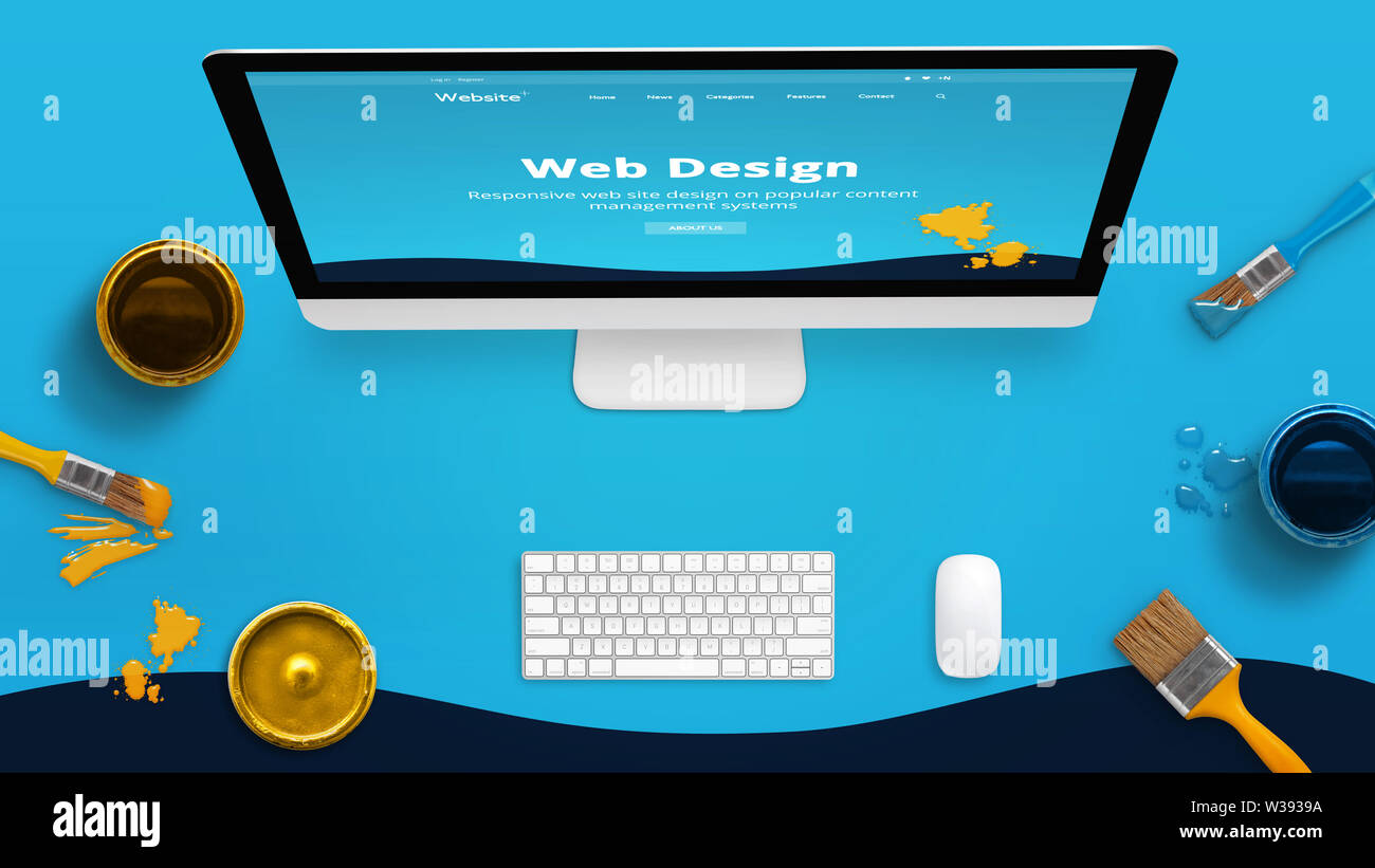 Web desing theme on computer display on blue desk, surrounded with ...