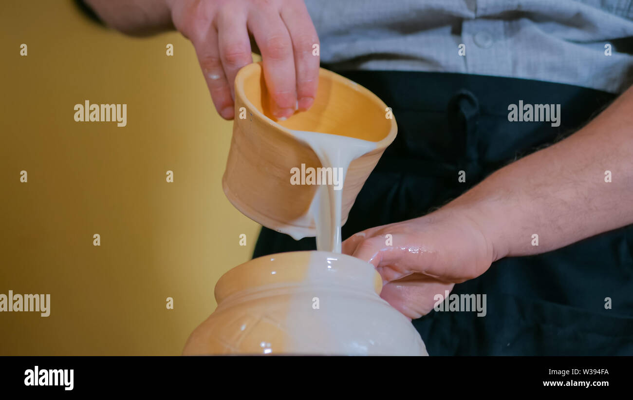 Potter preparing ceramic wares for burning Stock Photo - Alamy