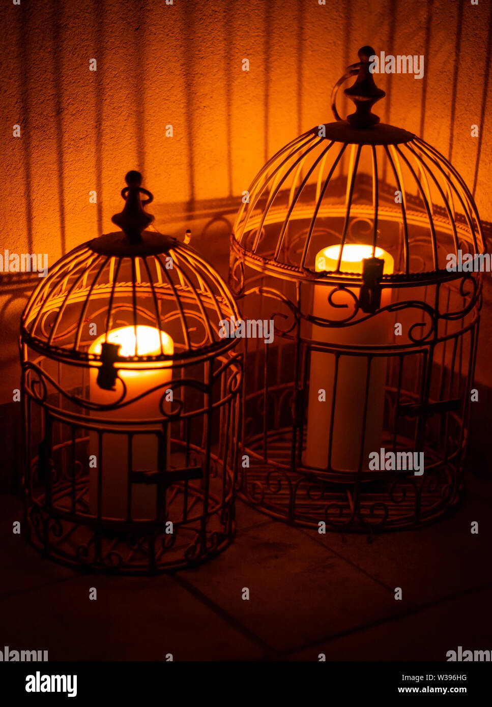Caged candle lights with shadows on the wall Stock Photo - Alamy