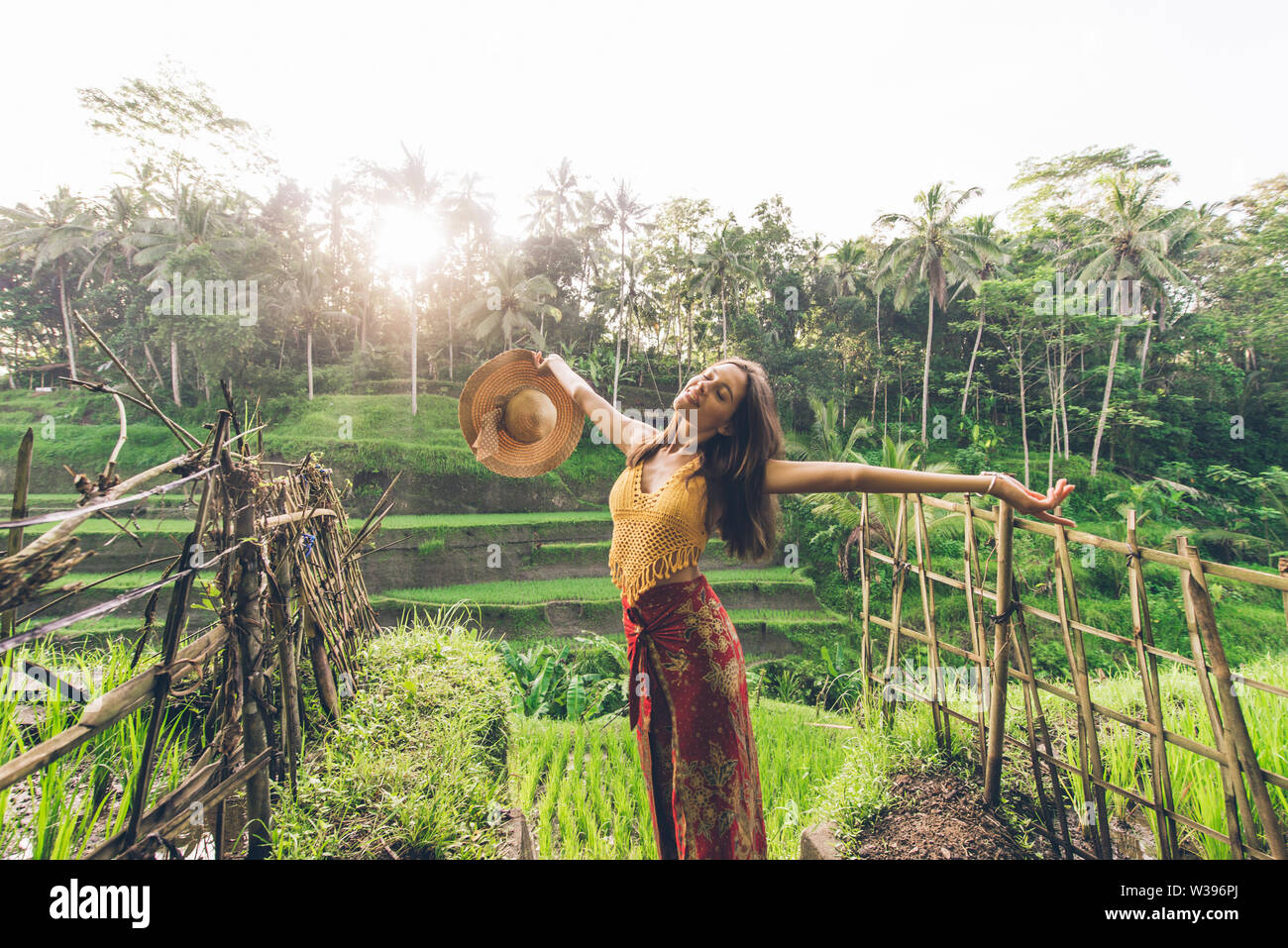 Young woman on green cascade rice field plantation at Tegalalang terrace. Bali, Indonesia ...