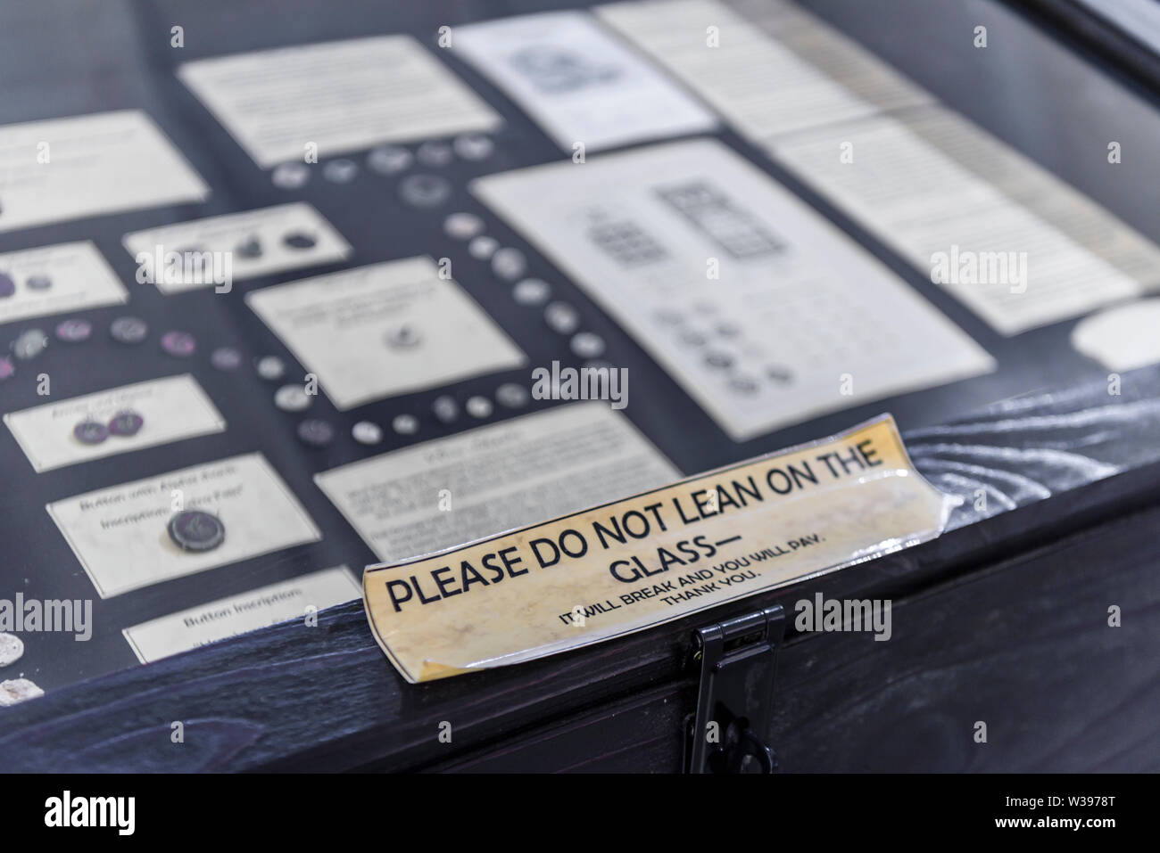 Sign on a museum display cabinet warning patrons not to lean on the ...