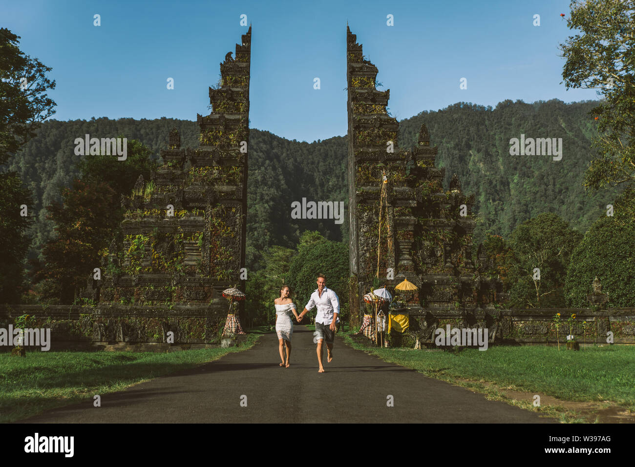 Couple of travelers at Handara Gate in Bali - Indonesia - Two tourists ...