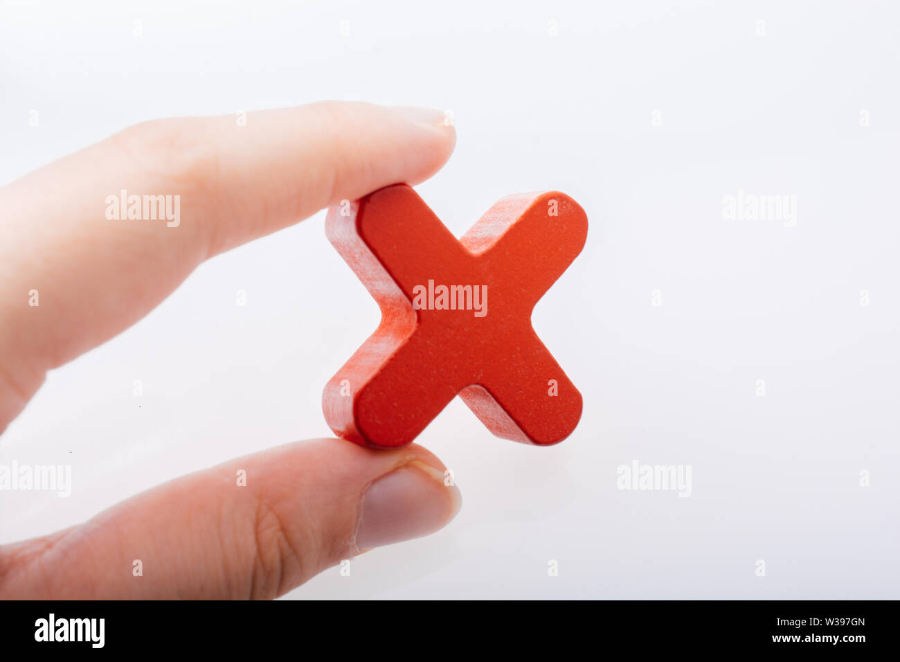 Hand holding letter cube X of made of wood Stock Photo - Alamy