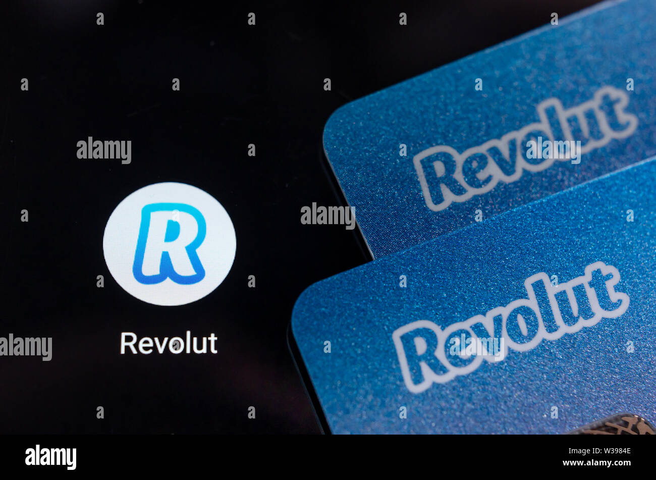 Revolut bank card on the smartphone screen next to app icon. Revolut ...