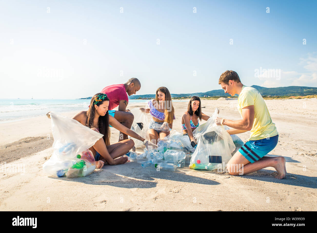 Teenagers clean beach waste hi-res stock photography and images - Alamy