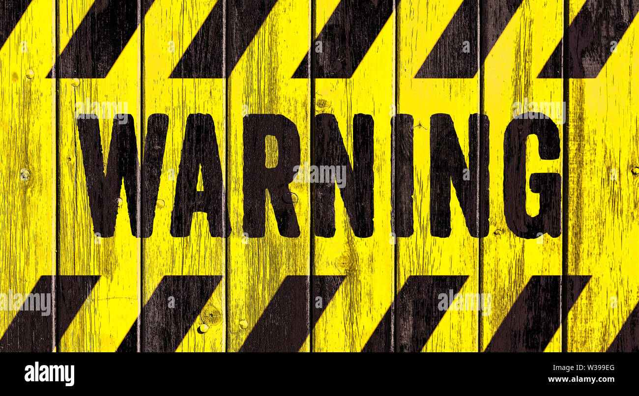 Warning danger sign word text as stencil with yellow and black stripes ...