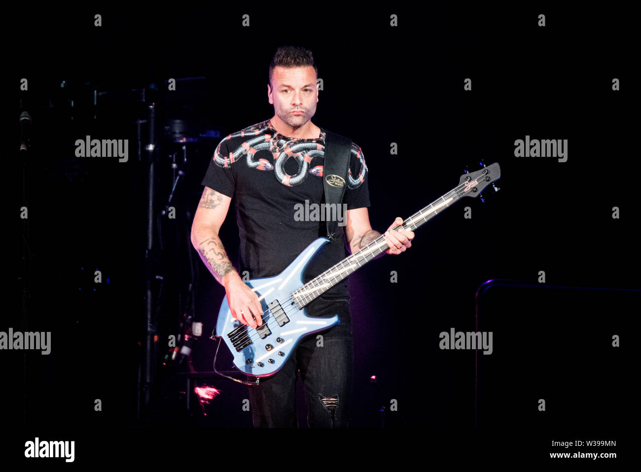 Chris Wolstenholme, bassist of the the English band Muse, performing ...