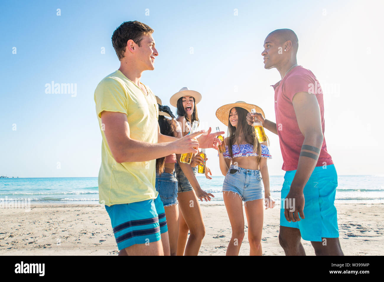 Group of friends having fun on the beach - Young and happy tourists ...