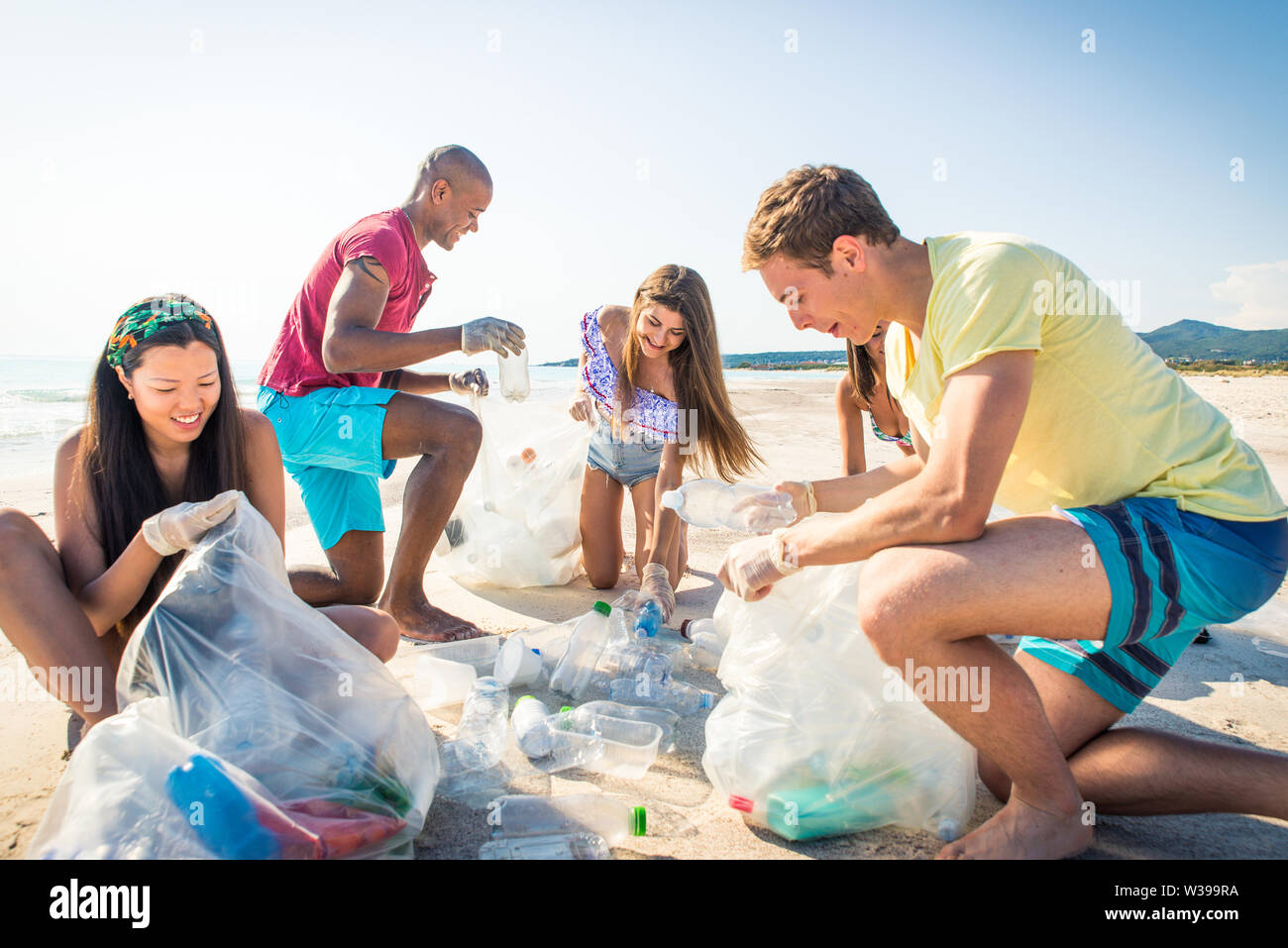 Teenagers clean beach waste hi-res stock photography and images - Alamy