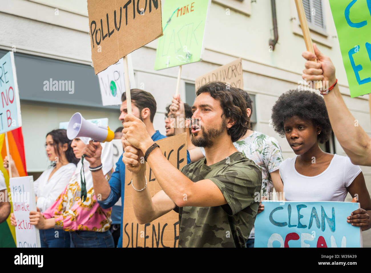 Group of activists is protesting outdoors - Crowd demonstrating against ...