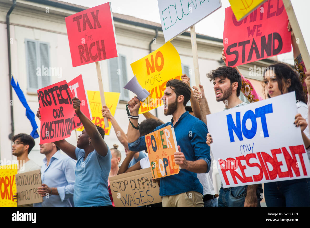 Group of activists is protesting outdoors - Crowd demonstrating against ...