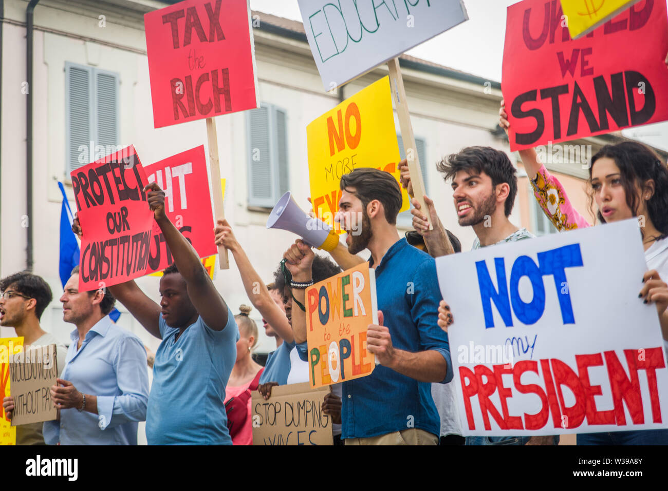 Group of activists is protesting outdoors - Crowd demonstrating against ...