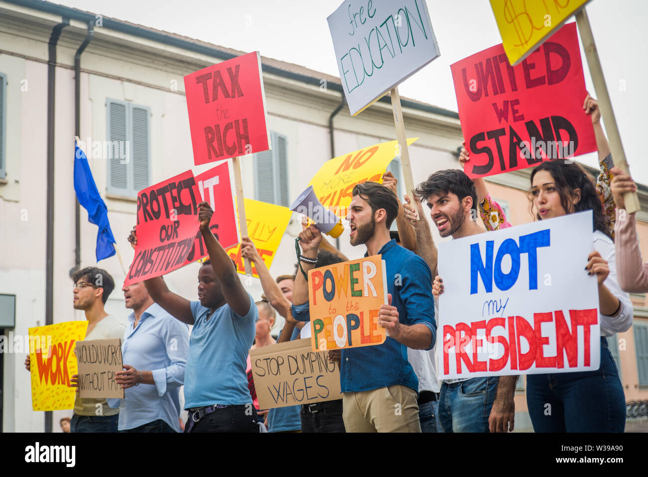 Group of activists is protesting outdoors - Crowd demonstrating against ...