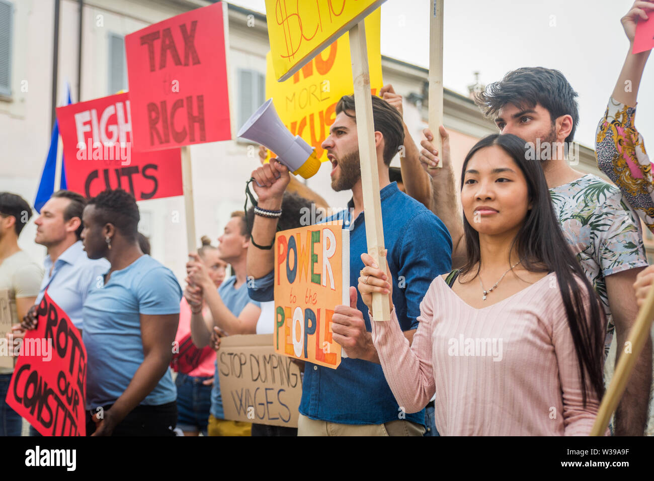 Group of activists is protesting outdoors - Crowd demonstrating against ...