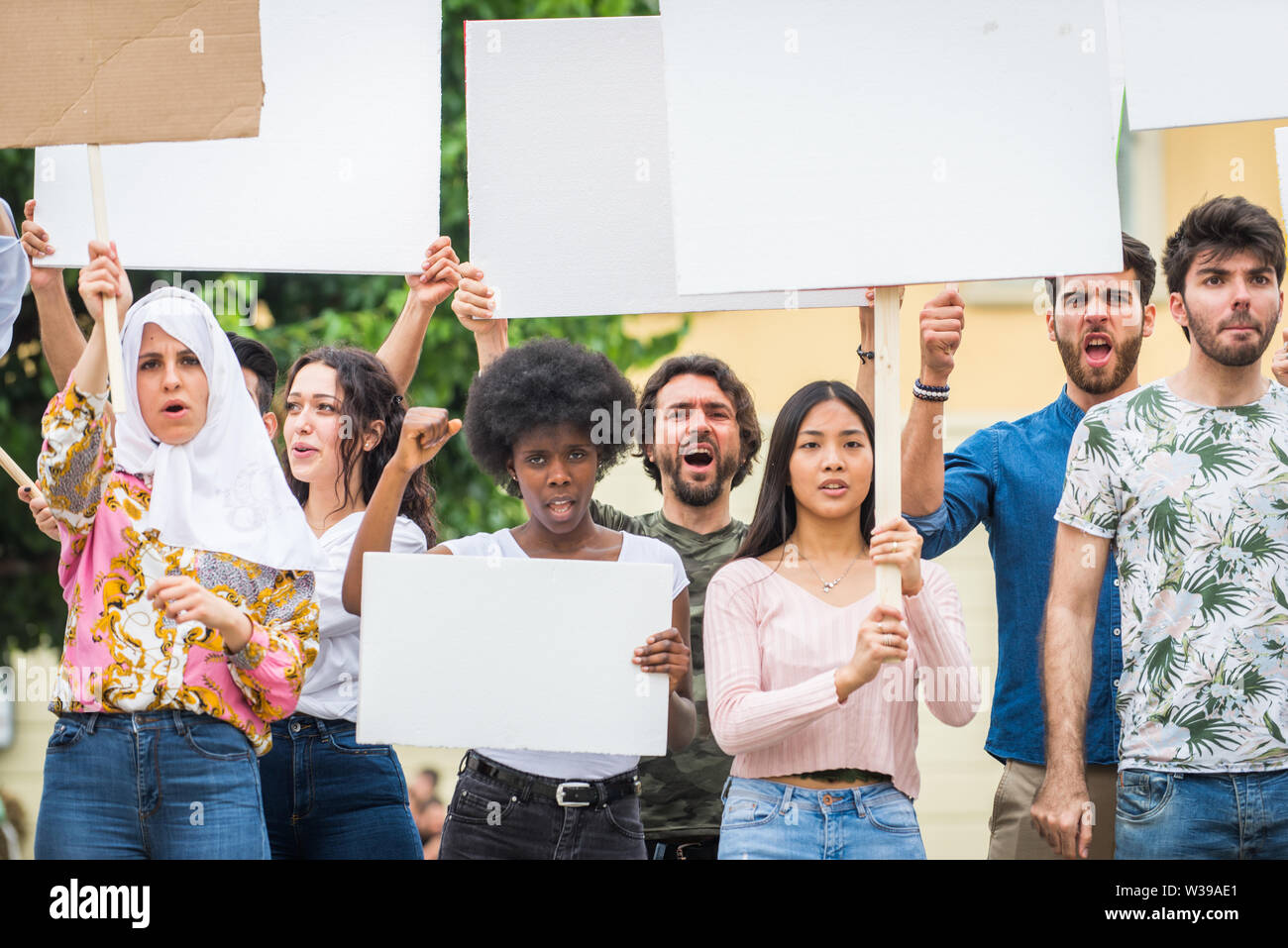 Group of activists is protesting outdoors - Crowd demonstrating against ...