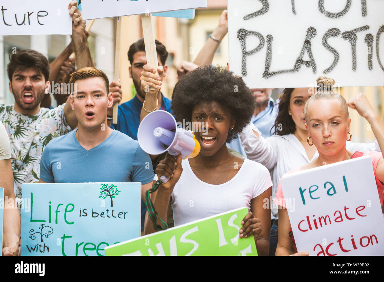Group of activists is protesting outdoors - Crowd demonstrating against ...