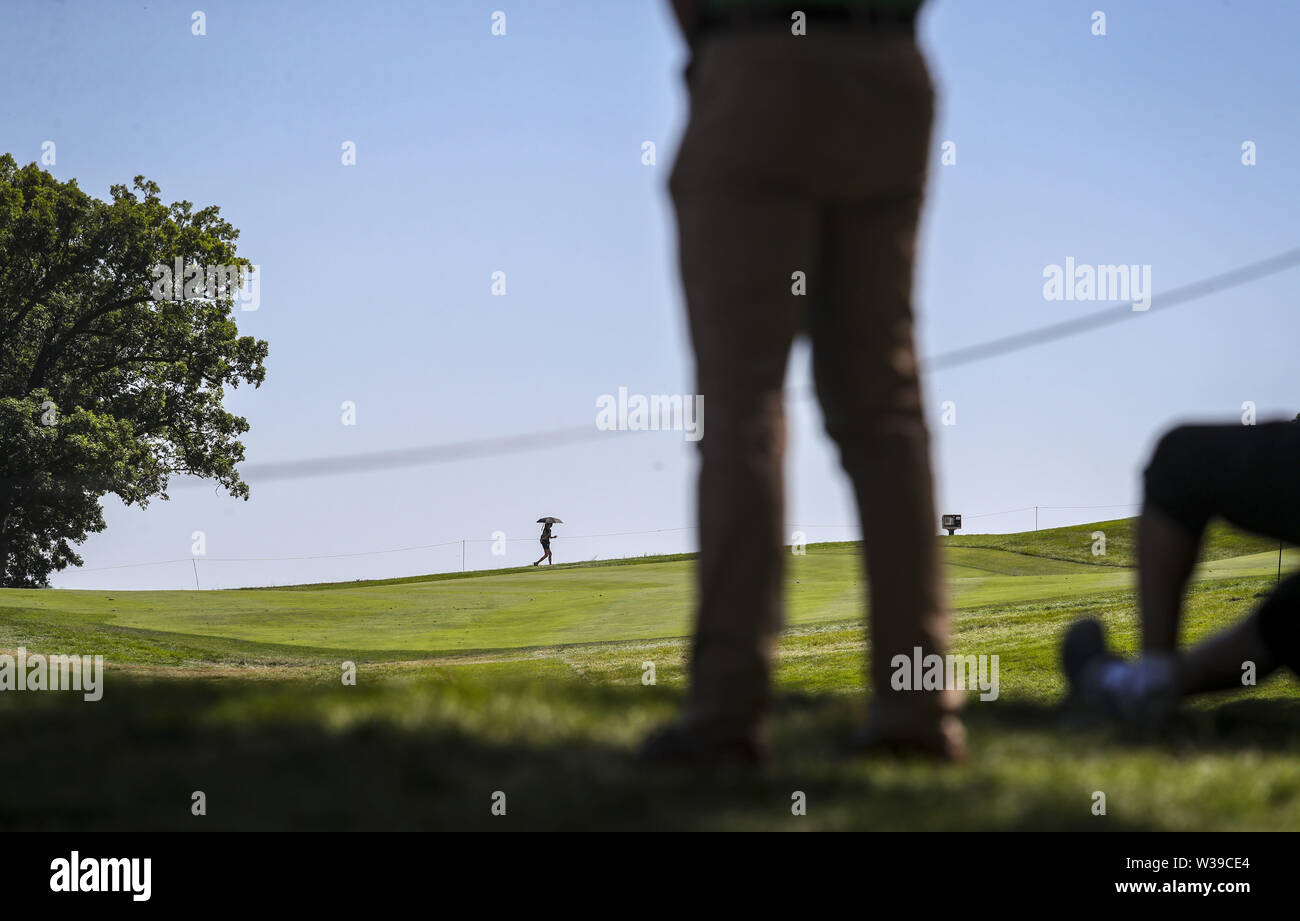 Silvis, Iowa, USA. 12th July, 2019. A spectator walks along the fifth ...