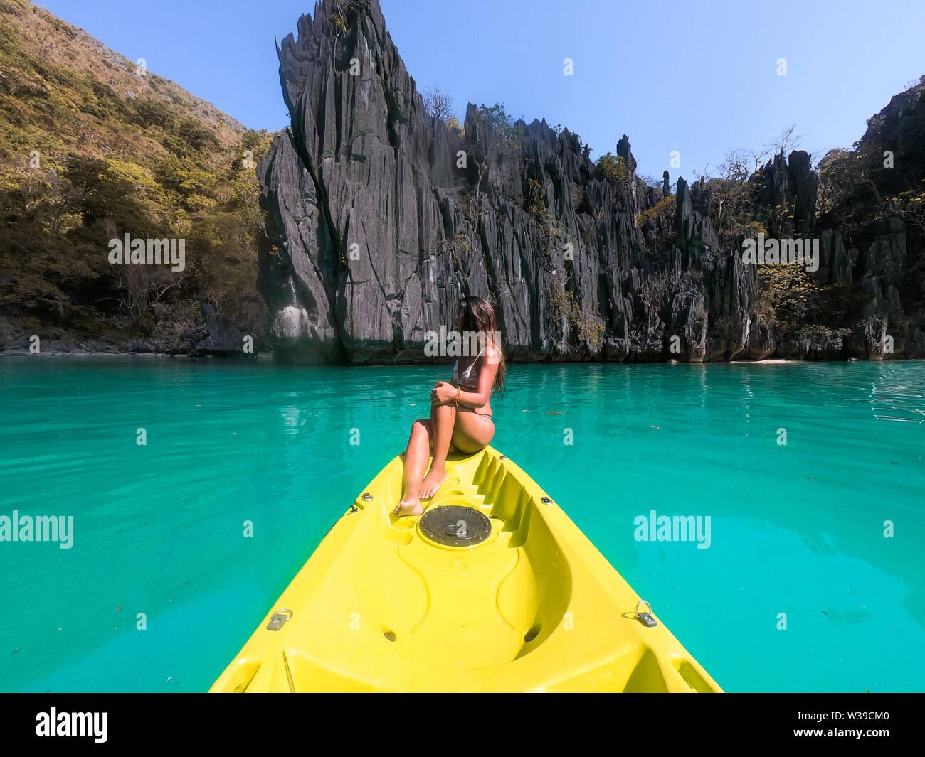 Couple kayaking on a tropical beach with blue water and palm trees - El ...