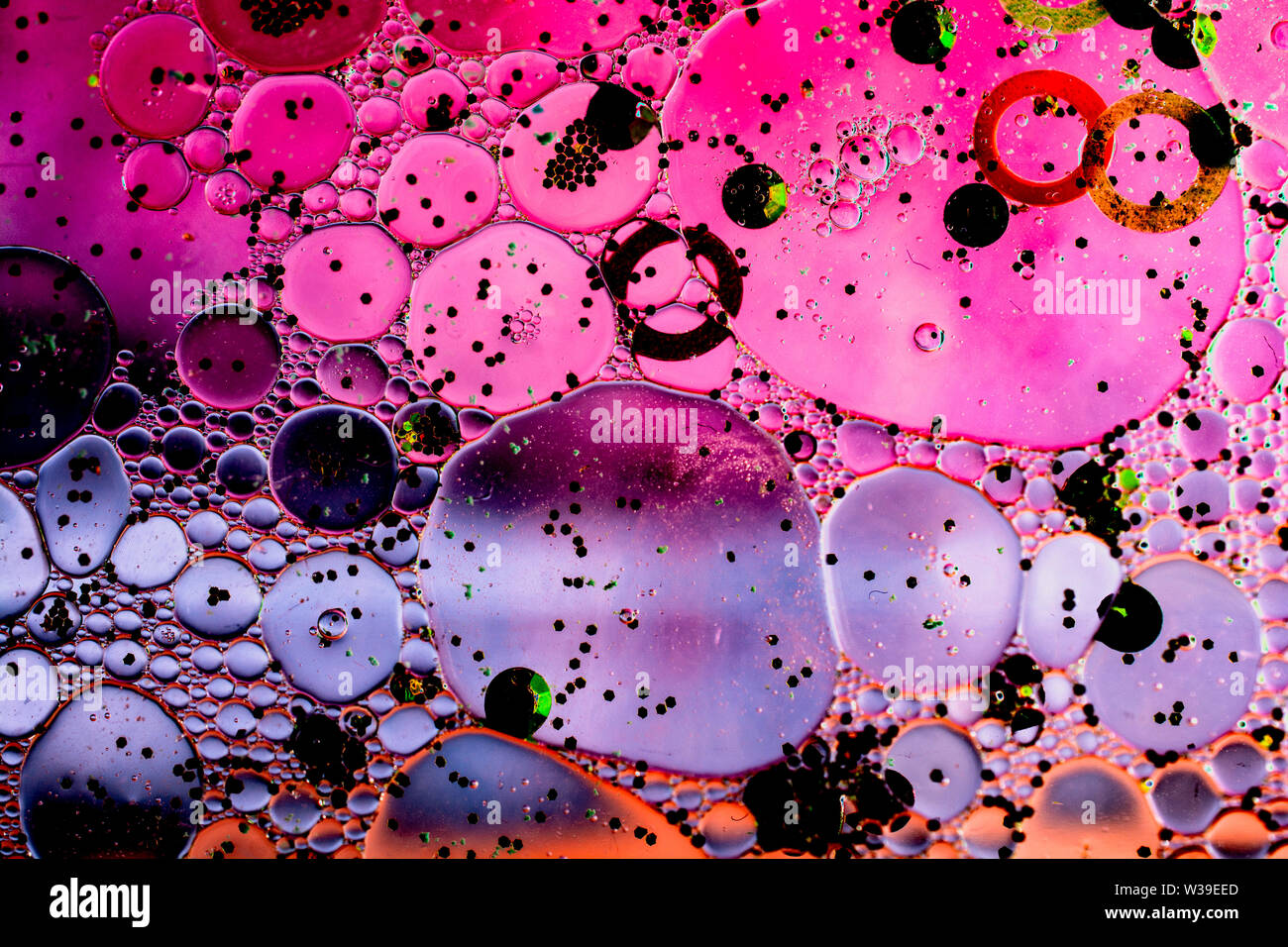 Oil bubbles inside water base form patterns Stock Photo - Alamy