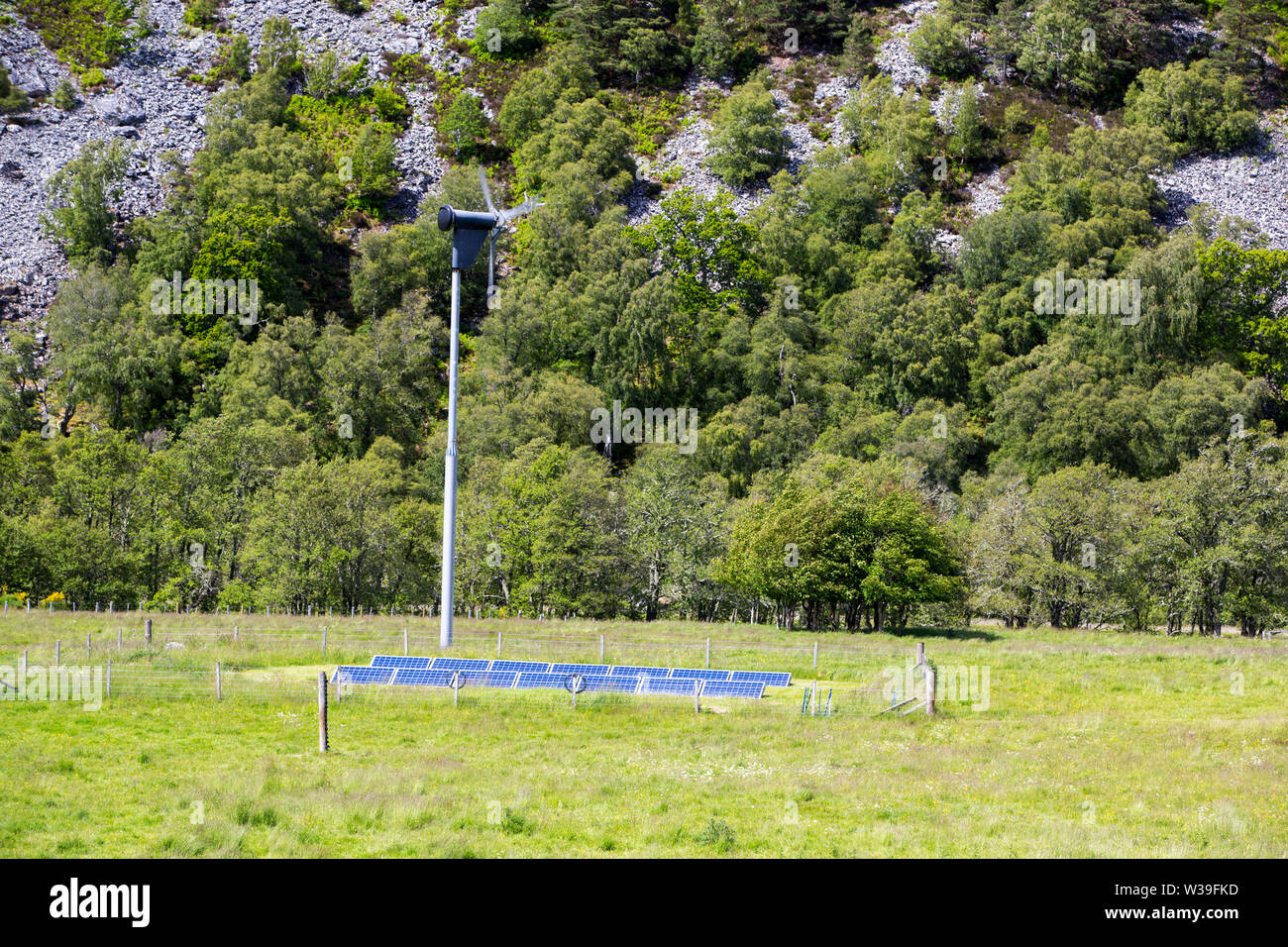 Solar panels and a wind turbine powering an off grid house at East ...