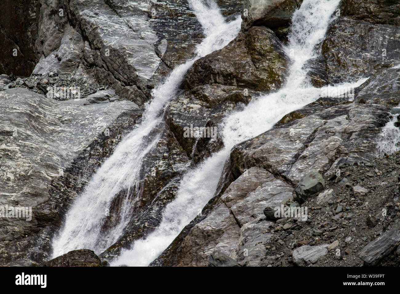 Small waterfalls at rock face formed by rain Stock Photo - Alamy