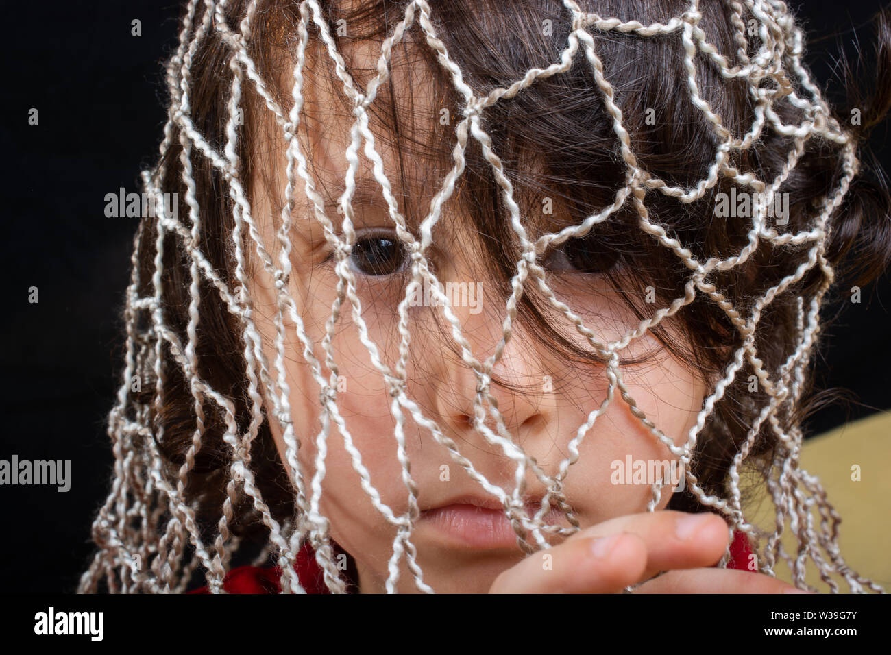Little boy trapped in a net as captivity Stock Photo - Alamy